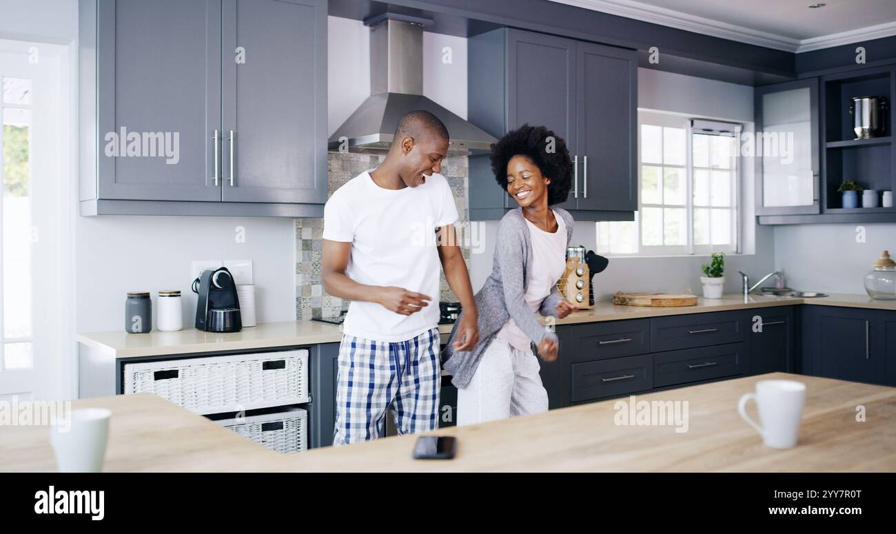Couple, kitchen and happy with dancing in morning for bonding together ...