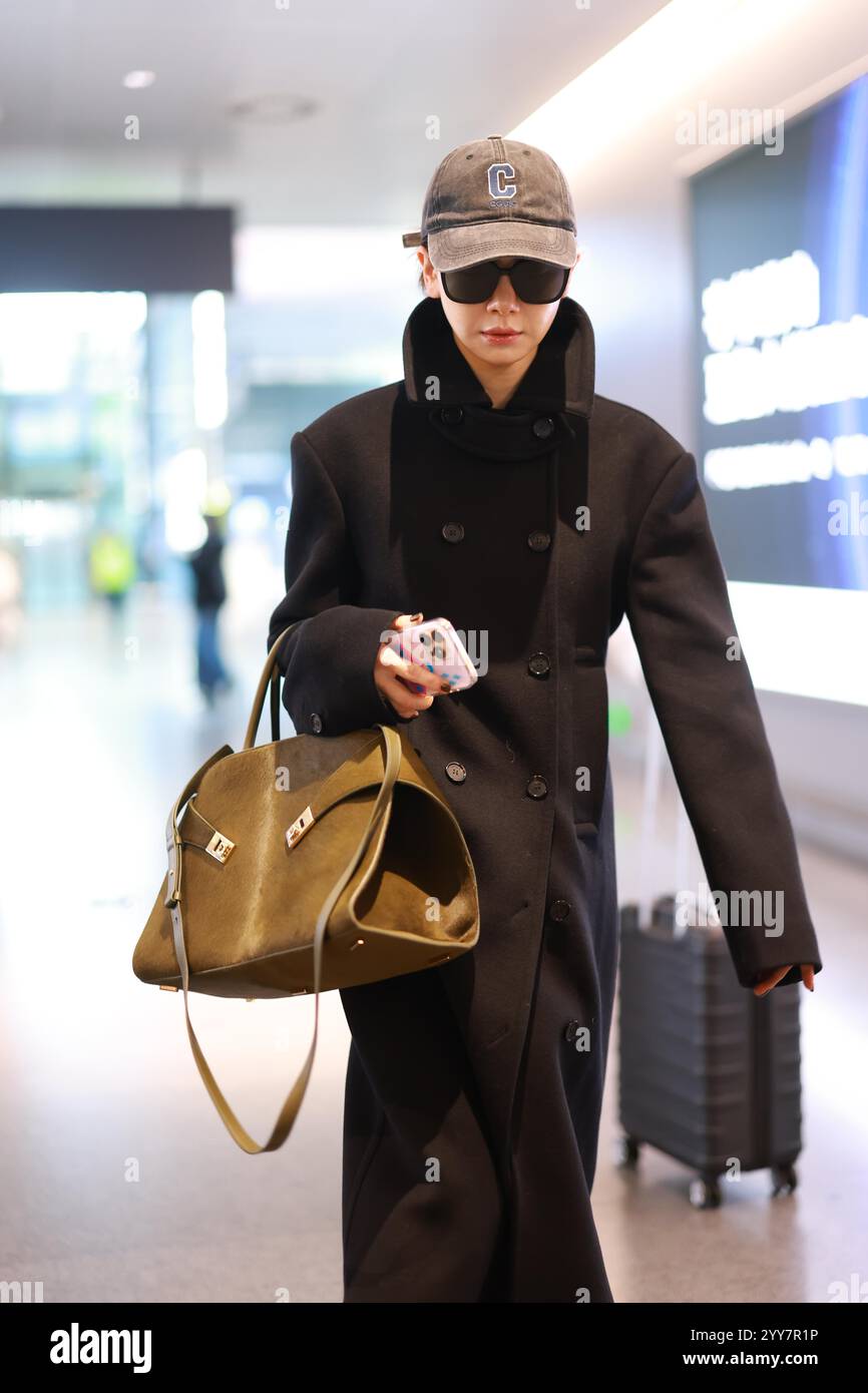 Chinese singer and actress Stephy Qi appears at the airport in Shanghai ...