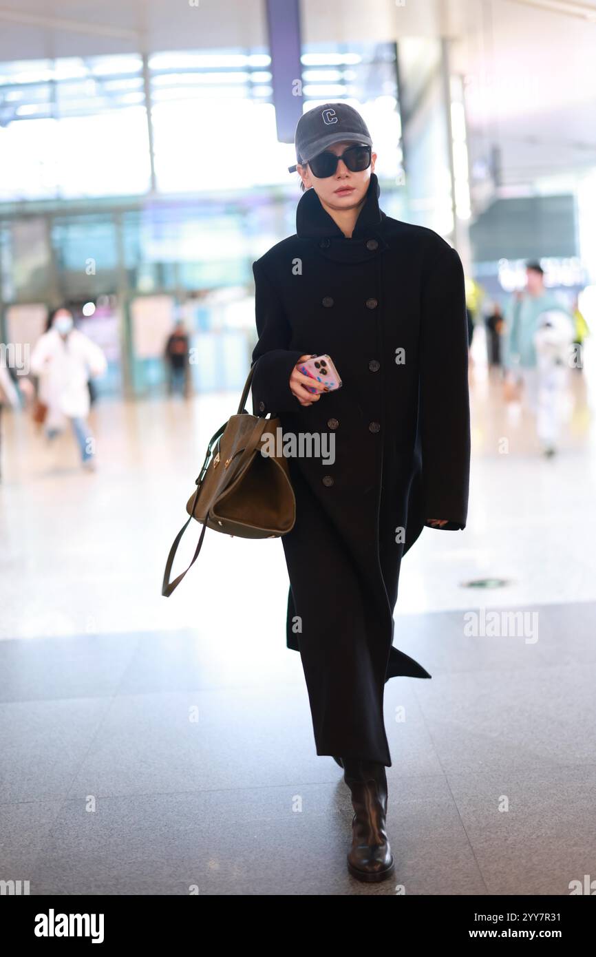 Chinese singer and actress Stephy Qi appears at the airport in Shanghai ...