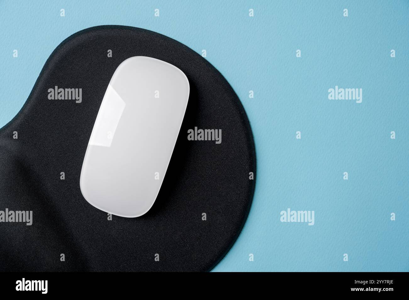 Top view of modern white mouse on black mousepad on blue table Stock ...