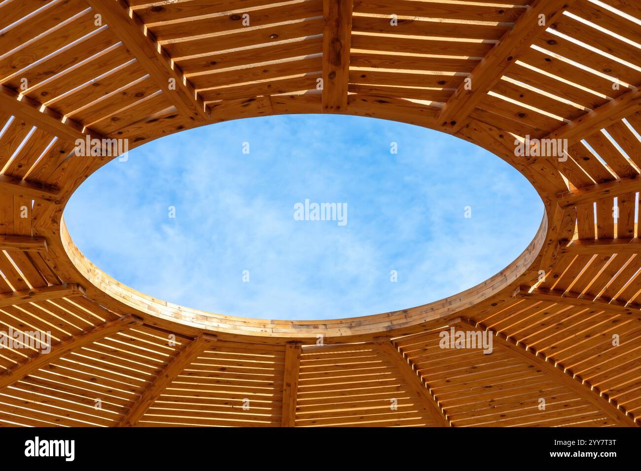 This captivating image features a circular wooden structure with an ...