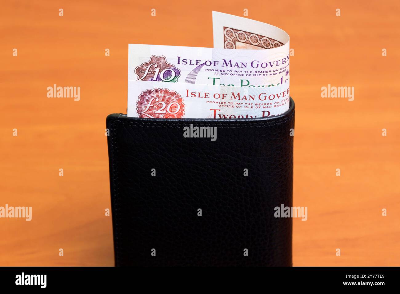 Manx money - pound in the black wallet Stock Photo - Alamy