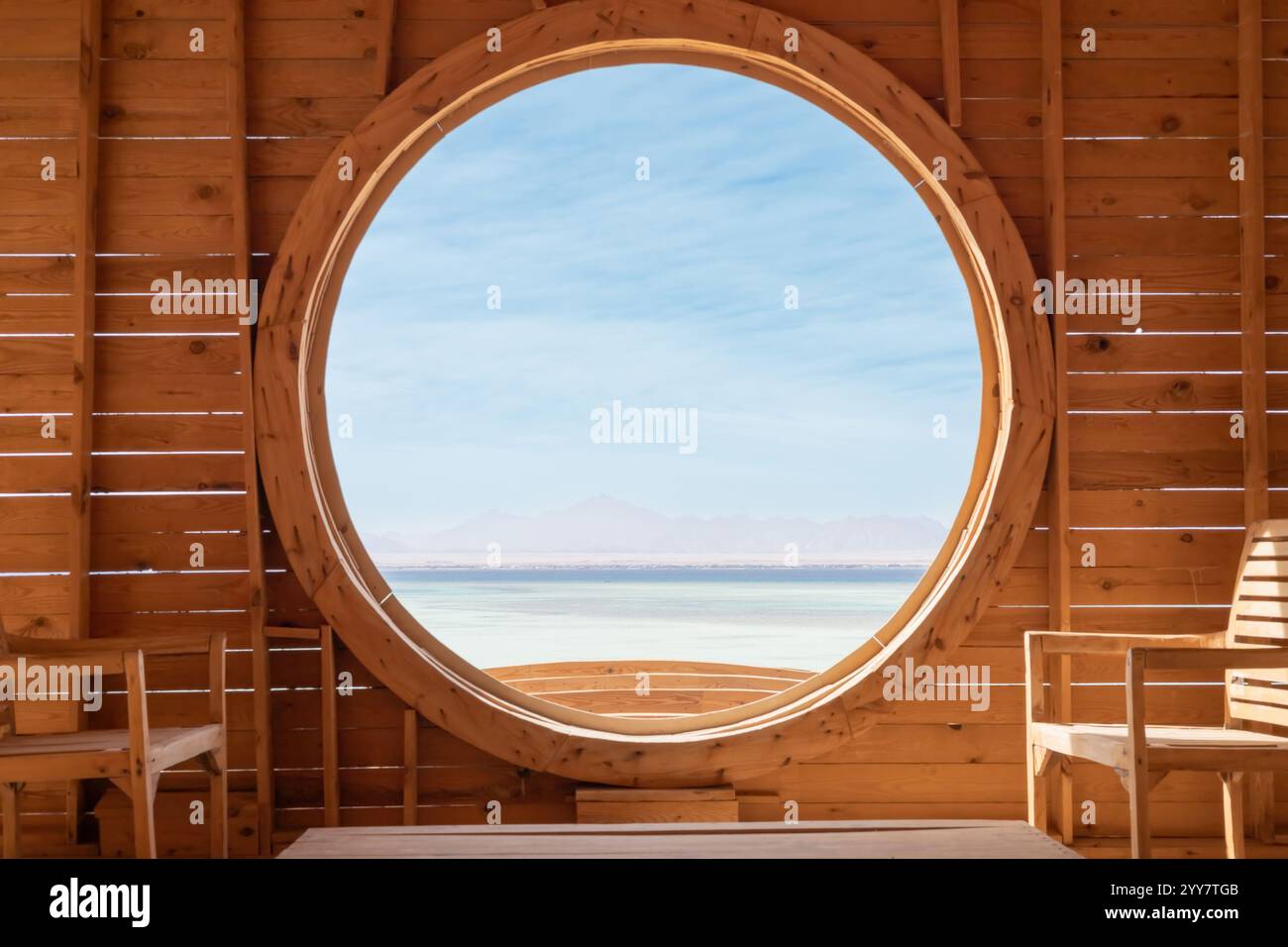 A tranquil indoor setting featuring a large circular window offering a ...