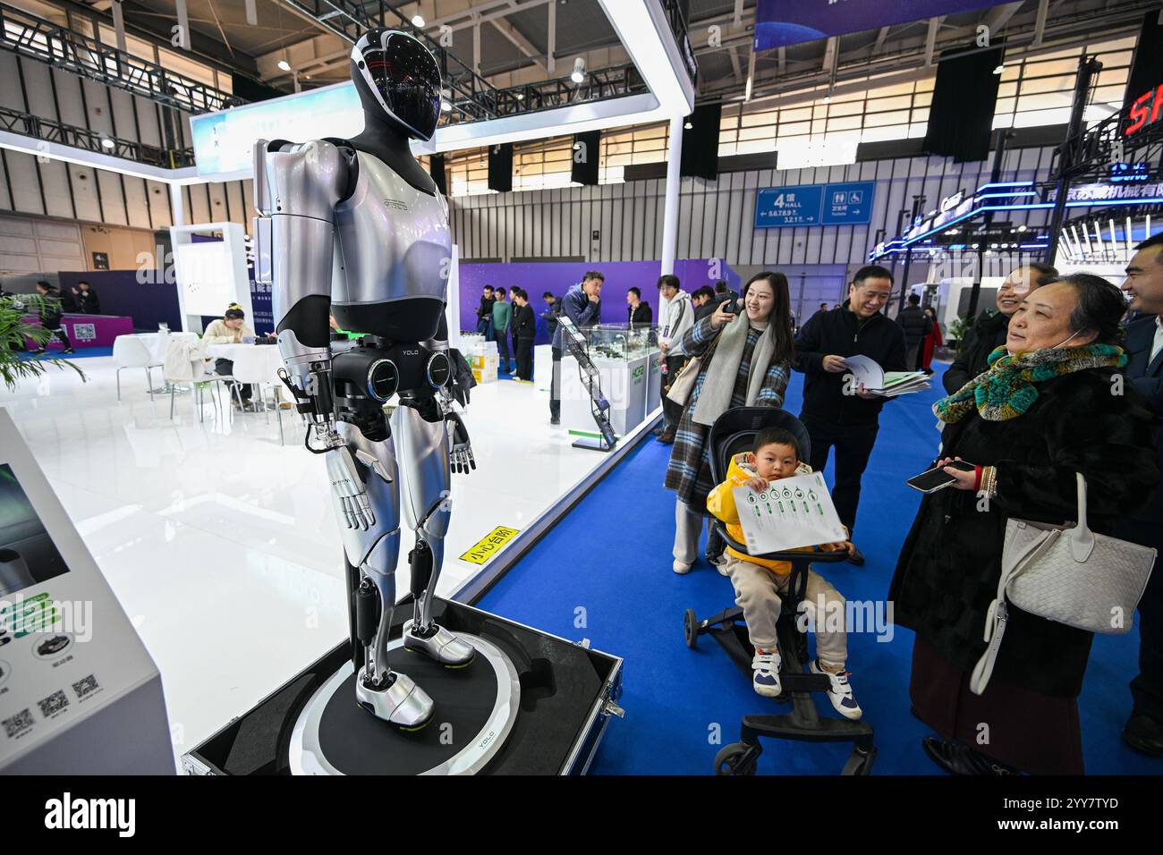 Visitors view a humanoid robot at the World Intelligent Manufacturing ...