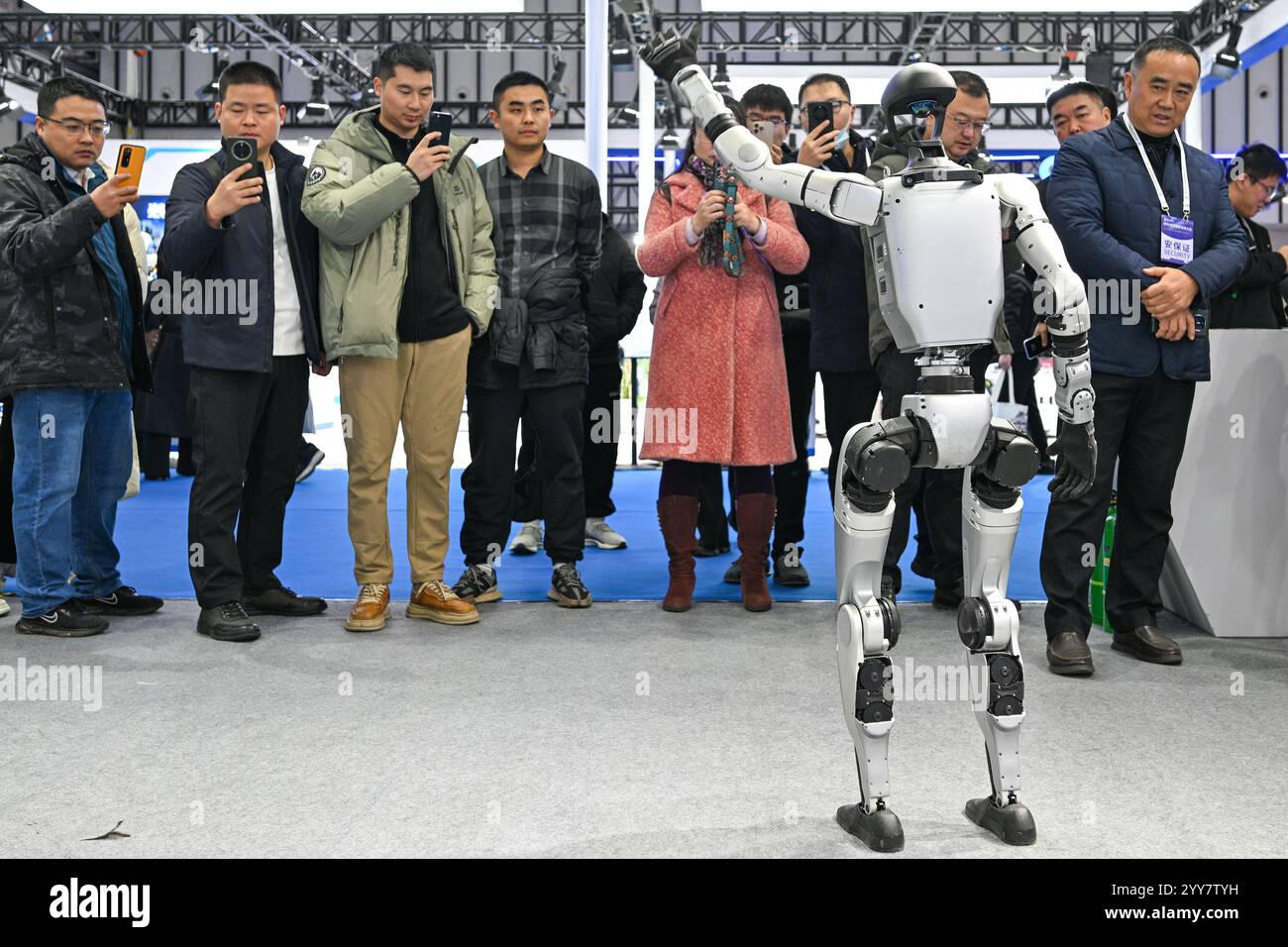 Visitors view a humanoid robot at the World Intelligent Manufacturing ...