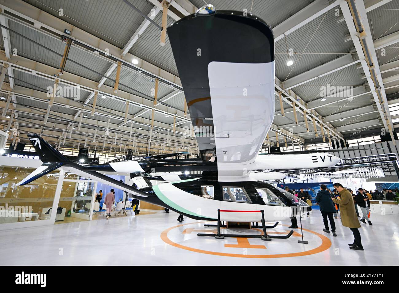 Visitors view electric vertical take-off and landing aircraft at the ...