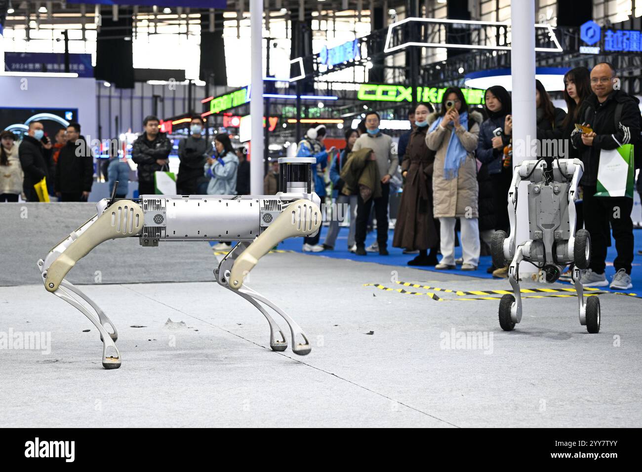 Visitors view a four-legged robot at the World Intelligent ...