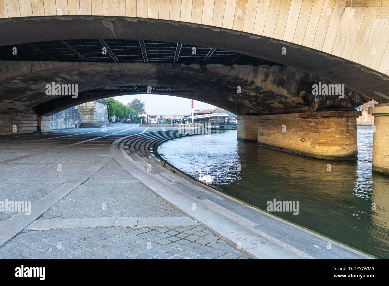 The serene waters of the Seine River flow beneath the Jena Bridge in ...