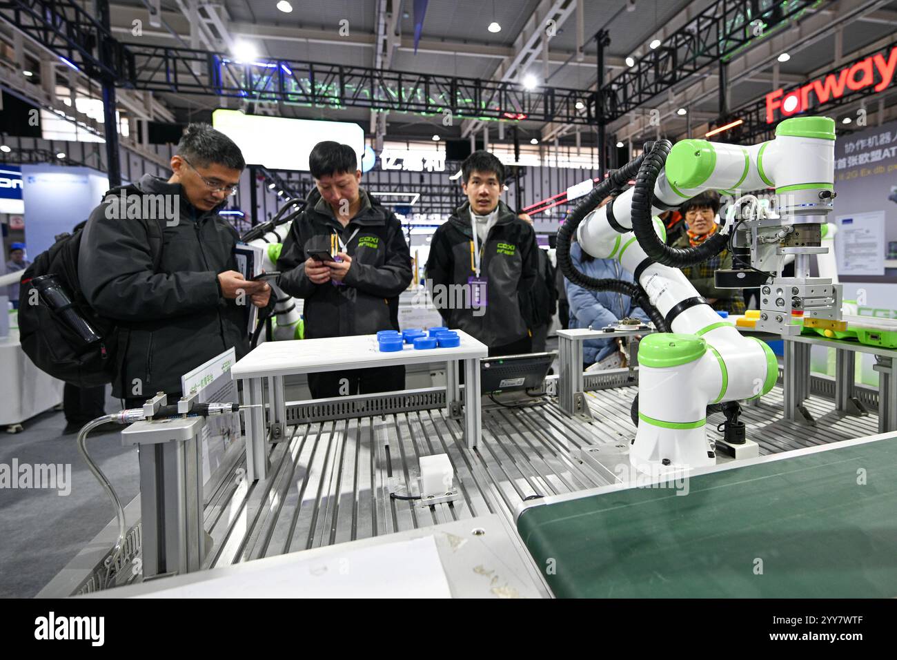 Visitors view smart devices at the World Intelligent Manufacturing Expo ...