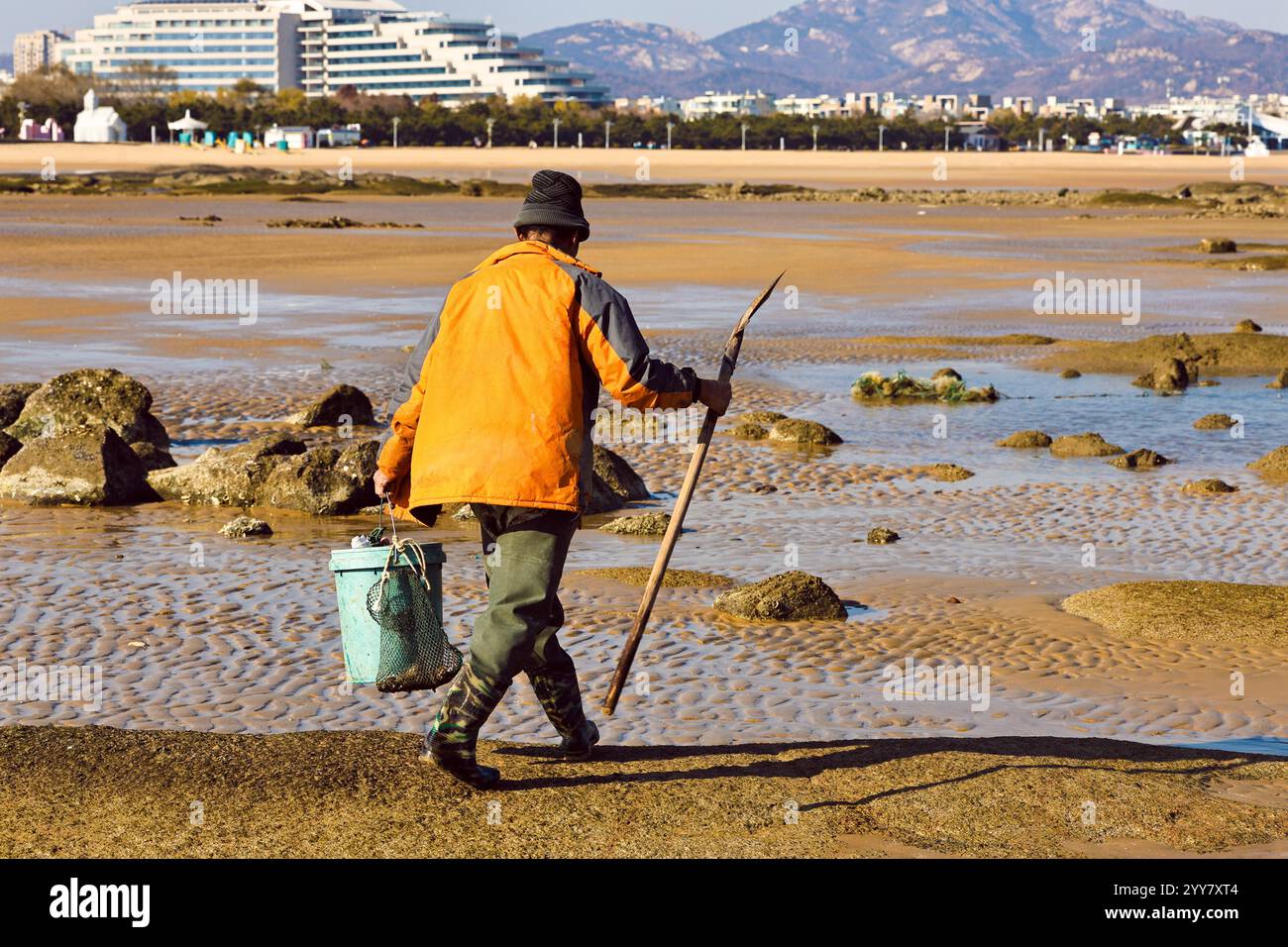 People go beachcombing at seaside in Rizhao City, east China's Shandong ...
