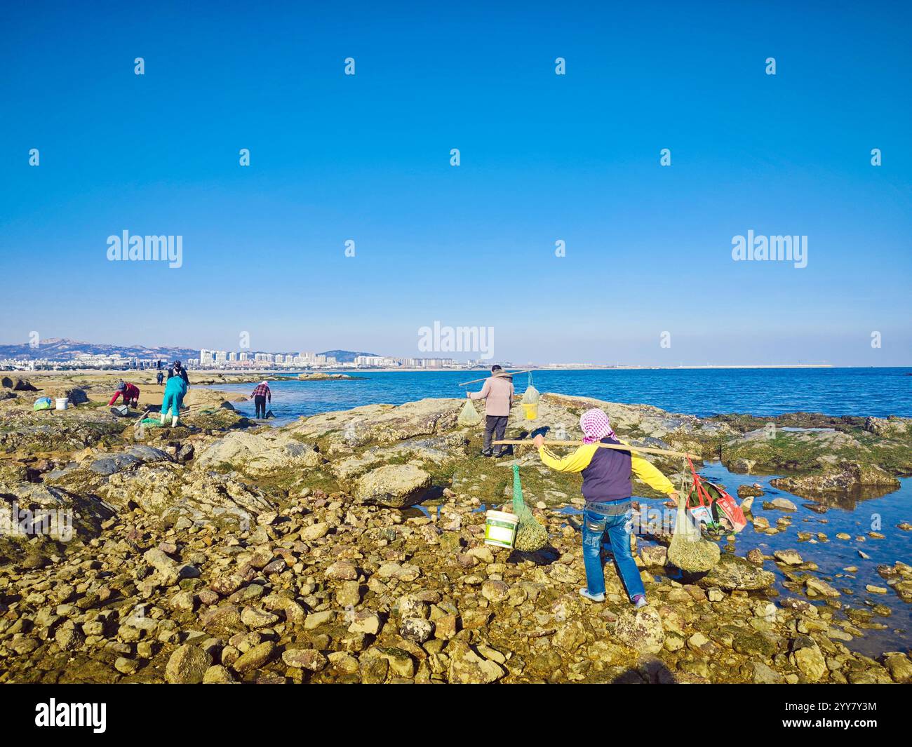 People go beachcombing at seaside in Rizhao City, east China's Shandong ...