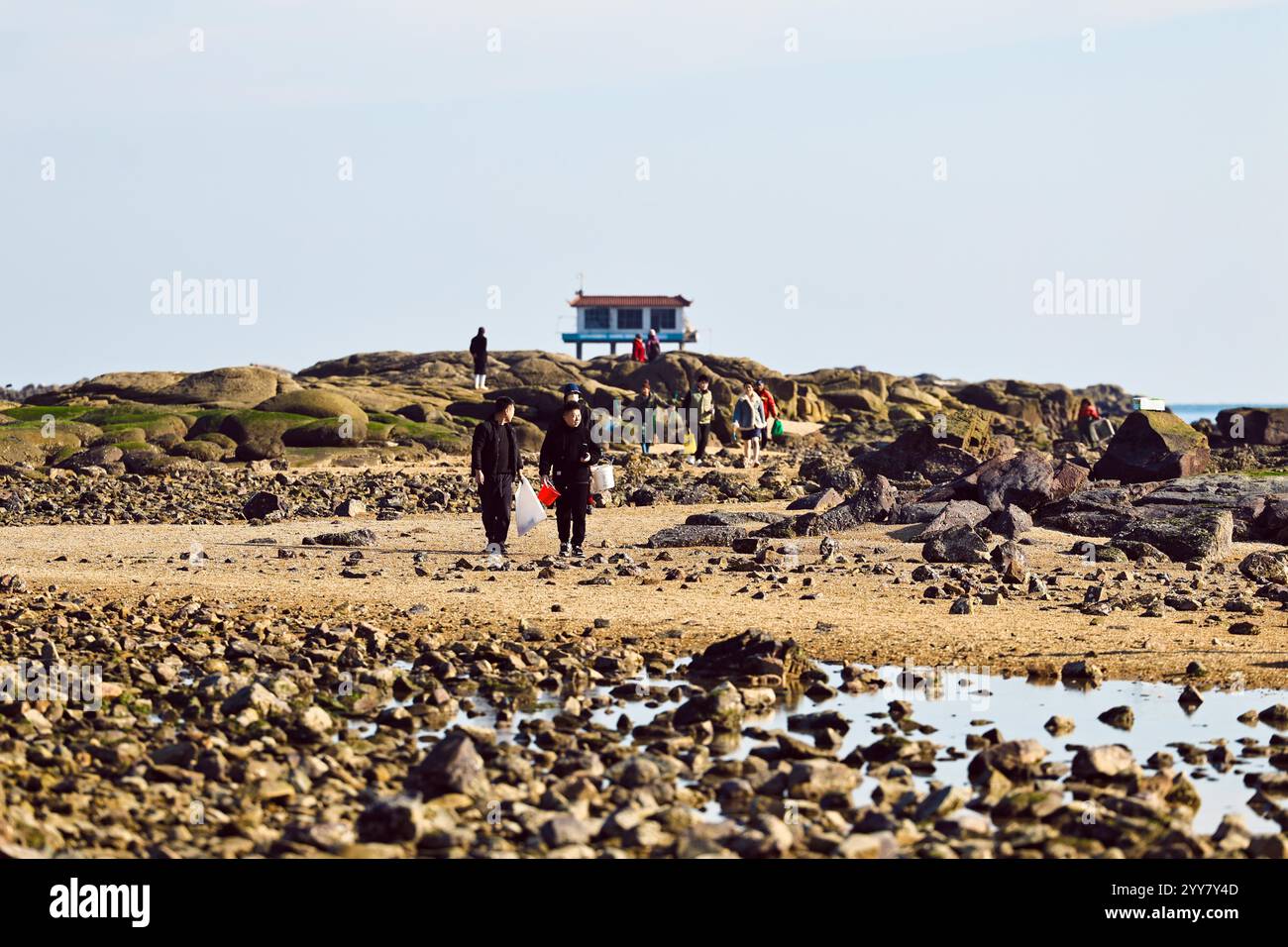 People go beachcombing at seaside in Rizhao City, east China's Shandong ...
