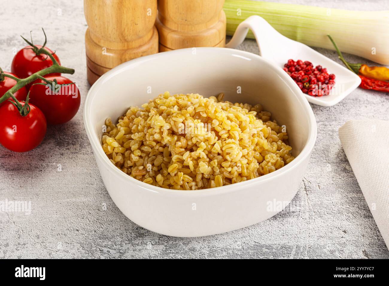 Boiled bulgur wheat in the bowl garnish Stock Photo - Alamy