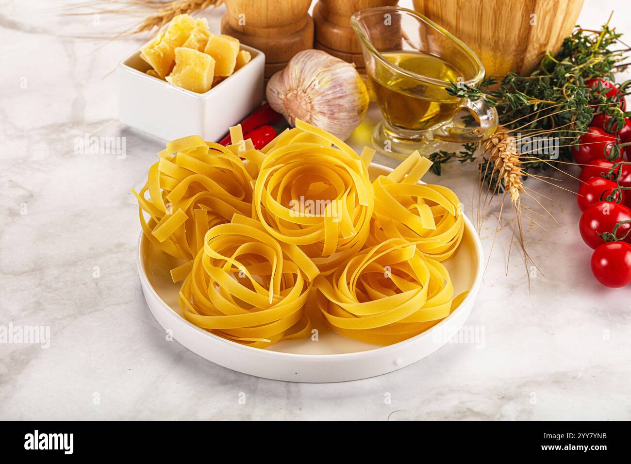 Raw dry Italian pasta - pappardelle for bowl Stock Photo - Alamy