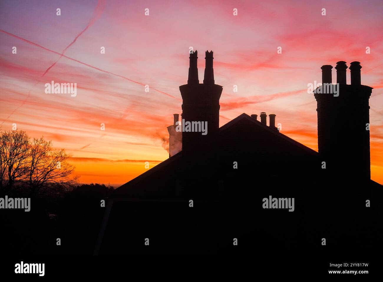 London, UK. 20 December 2024 . Chimney stacks and a residential rooftop ...