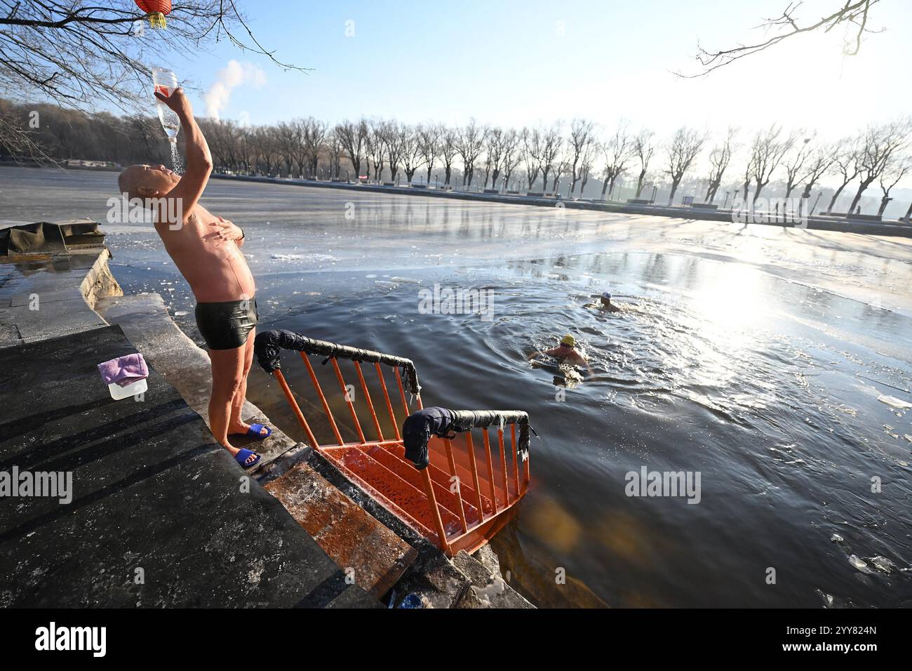 Winter swimming enthusiasts dive into the icy water in Shenyang City ...
