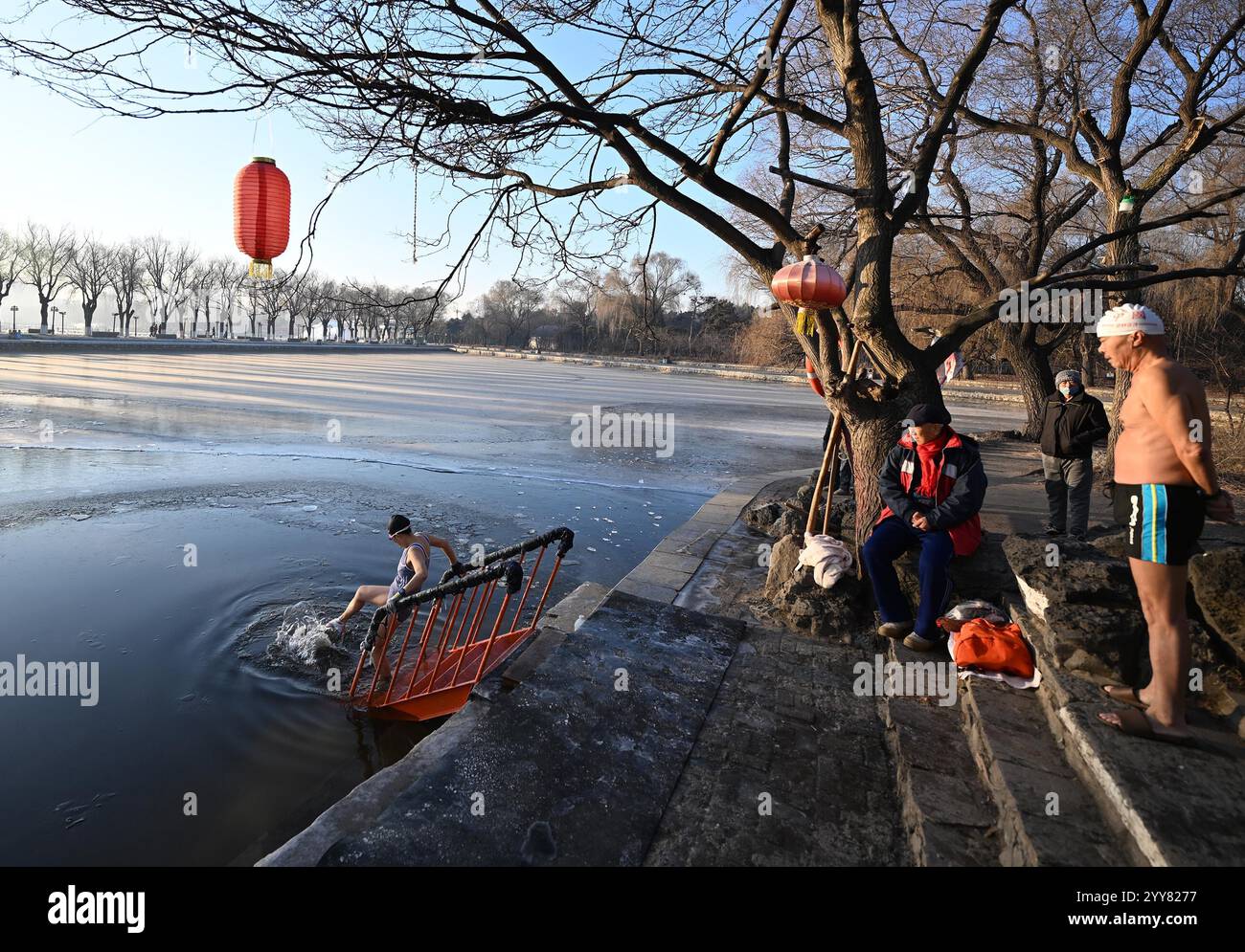 Winter swimming enthusiasts dive into the icy water in Shenyang City ...