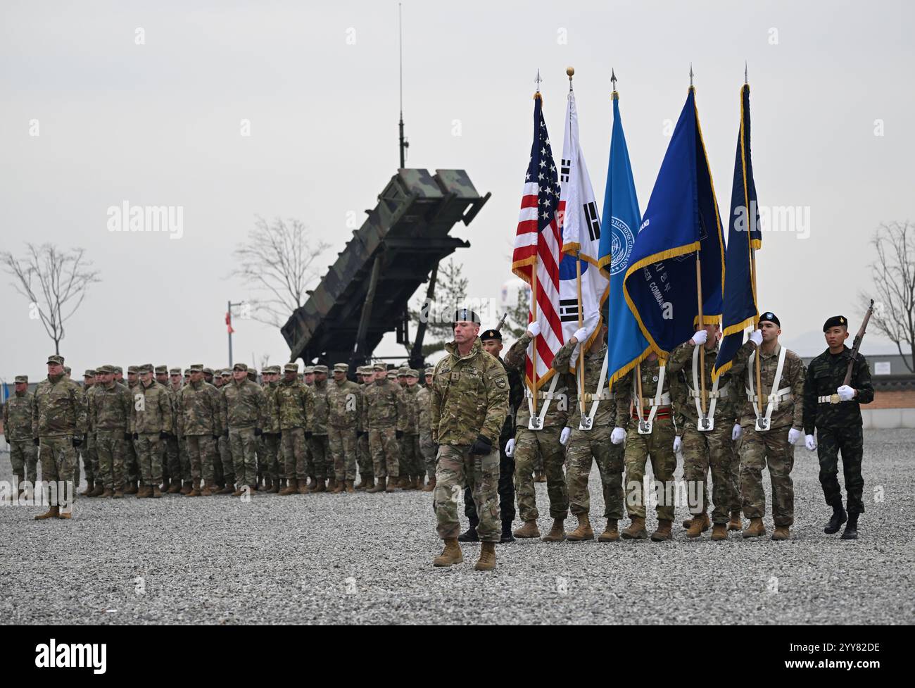 Members of the United Nations Command honor guard carry flags during a ...