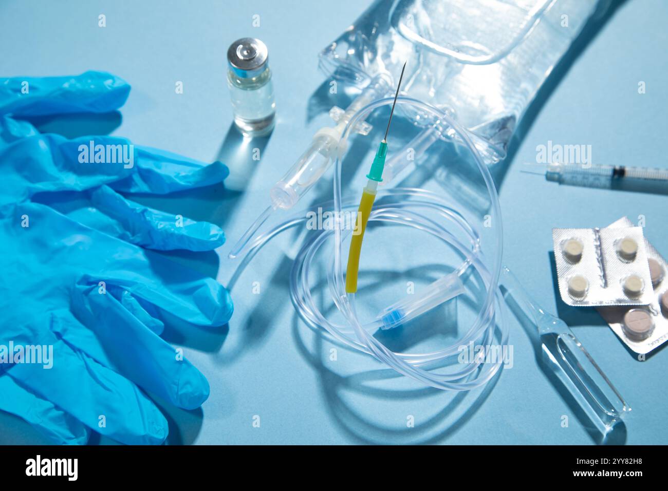 Infusion bag, syringe, medical ampoules in the blue background. IV drip ...