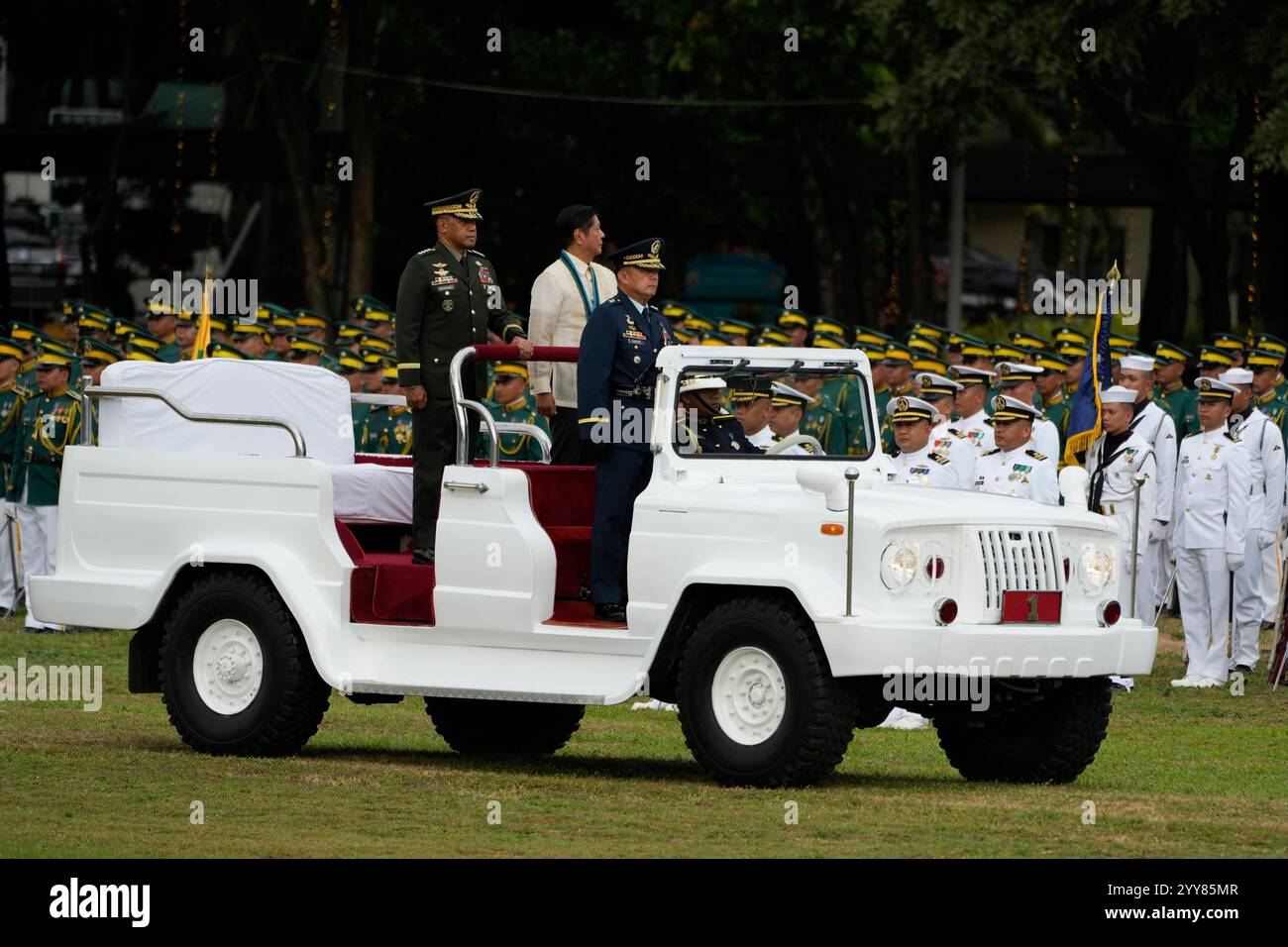 Philippine President Ferdinand Marcos Jr. , center, rides beside ...