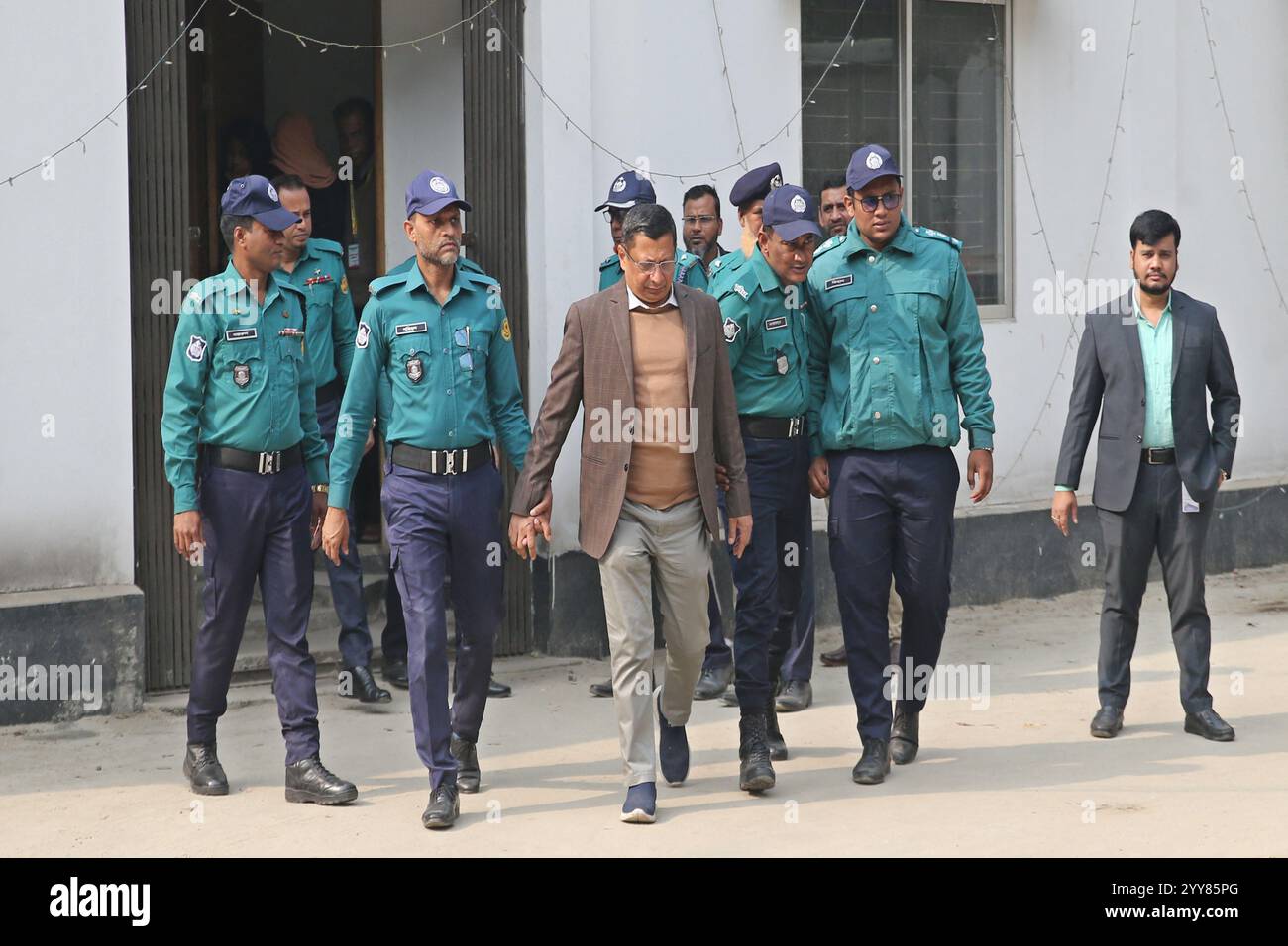 Police personnel escort detainees Chowdhury Abdullah Al-Mamun a former police inspector general ...