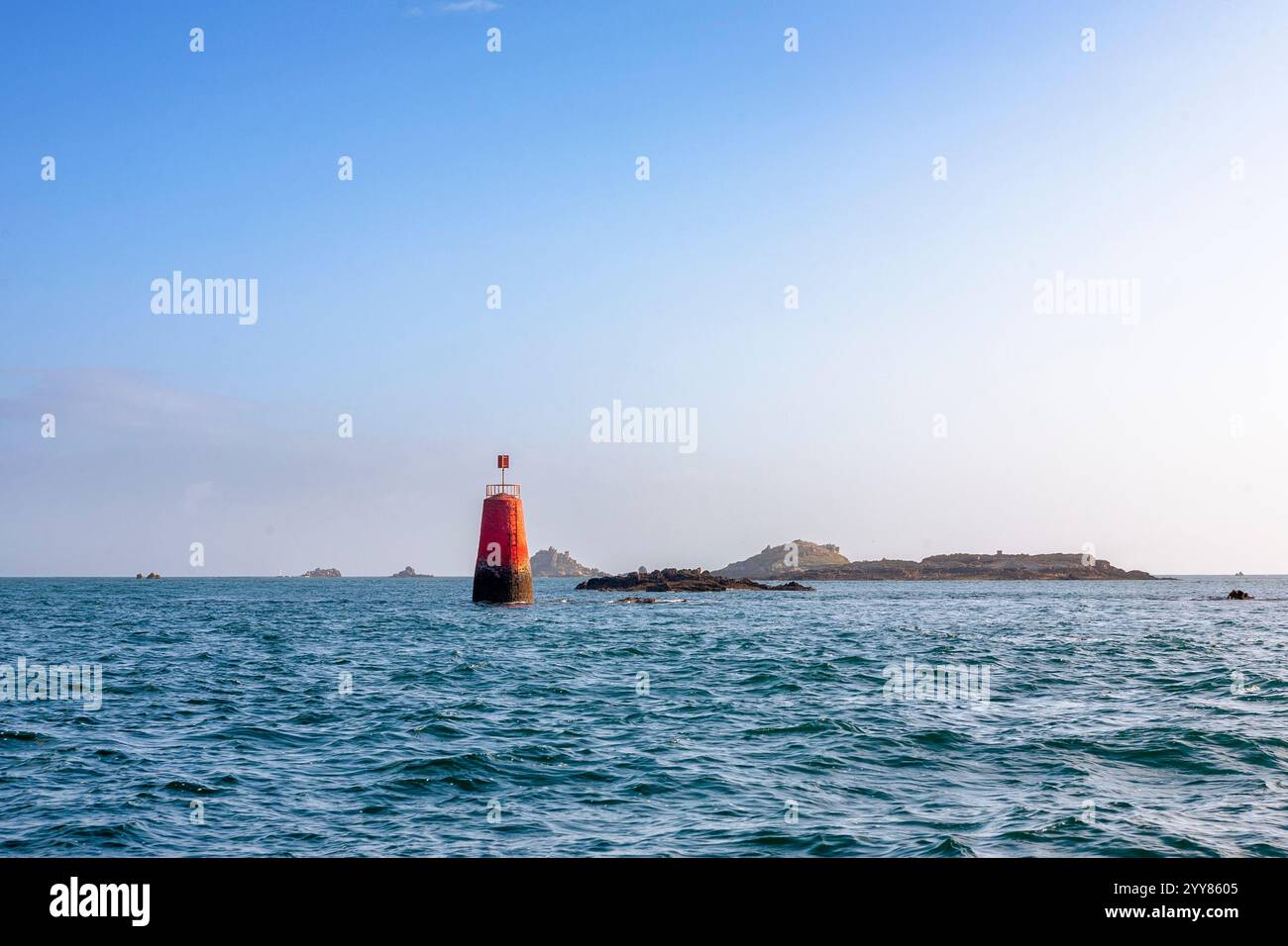 Port-hand channel marker in the Baie de Morlaix, surrounded by rocks ...