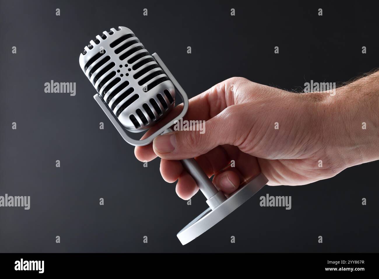 Radio broadcasting concept with hand holding a vintage style metal ...