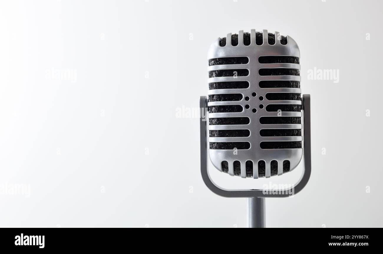 Detail of a vintage style metal condenser microphone with stand on a ...