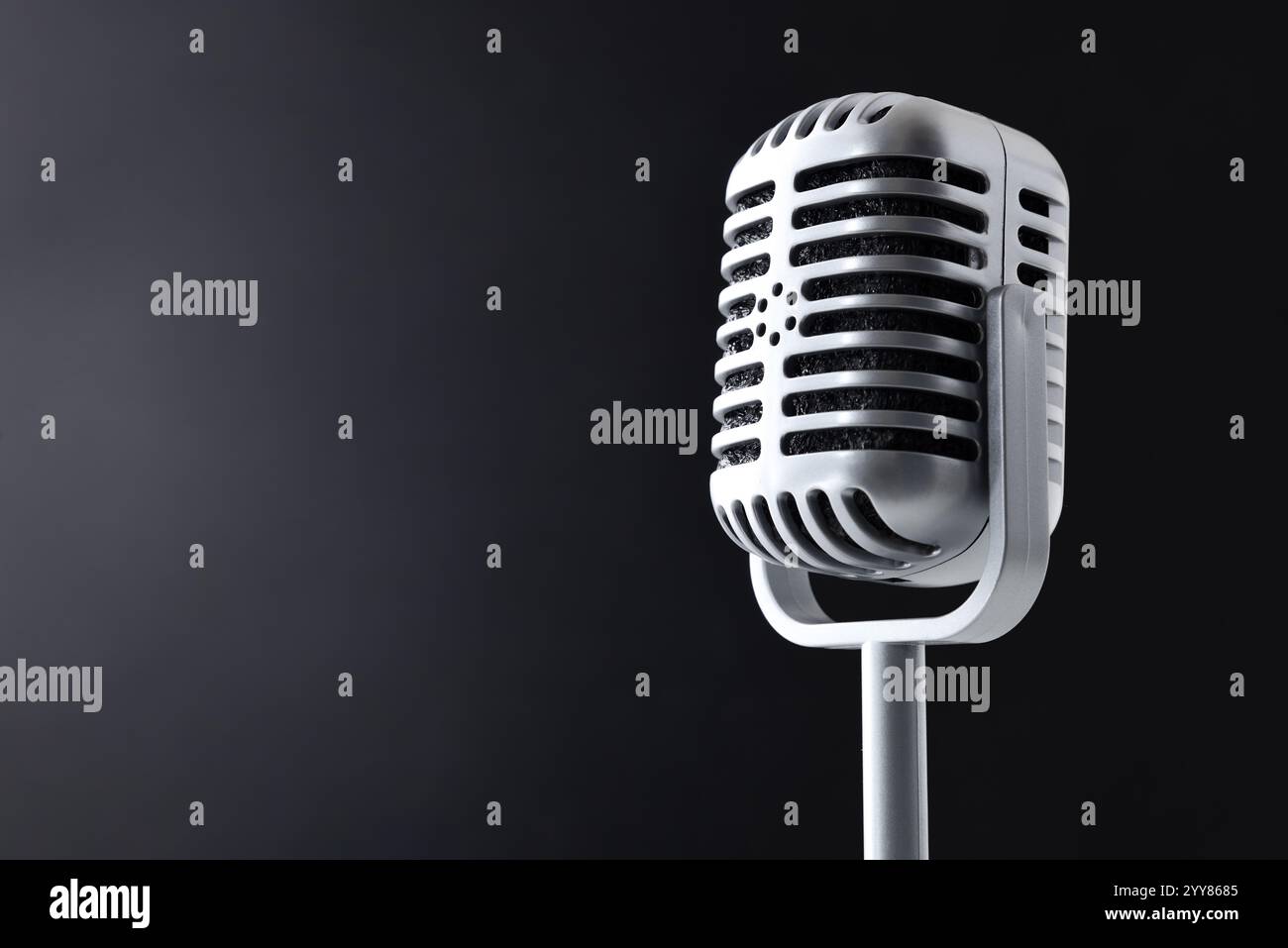 Detail of a vintage style metal condenser microphone with stand on a ...