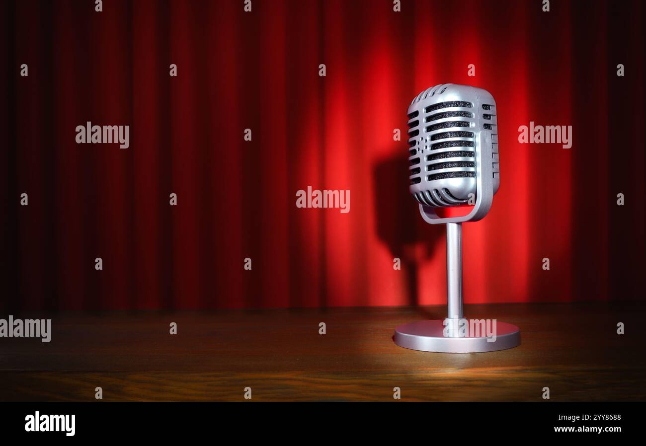 Vintage metal microphone with stand on a stage with wooden platform and ...