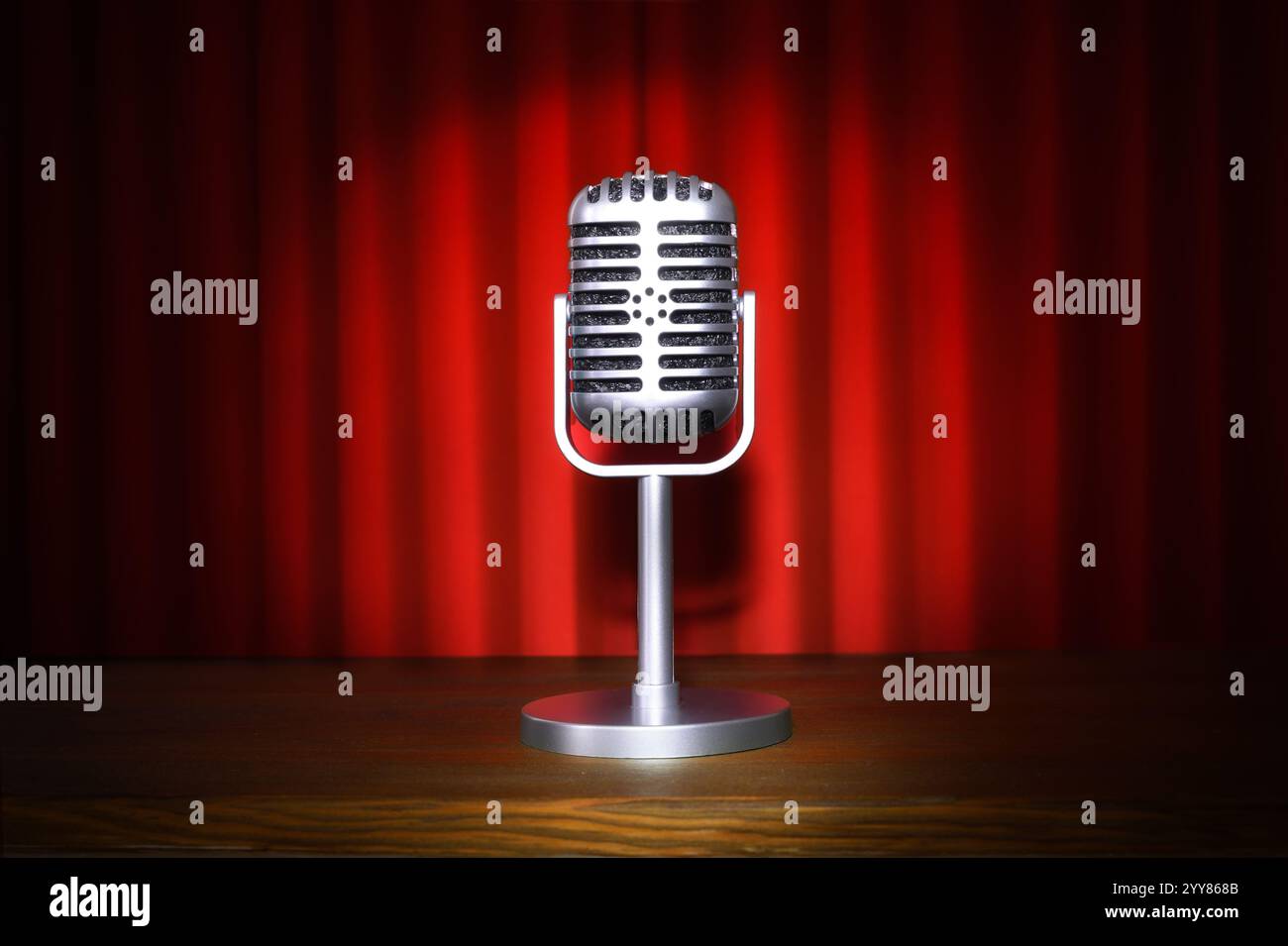 Vintage metal microphone with stand in the center of a stage with ...