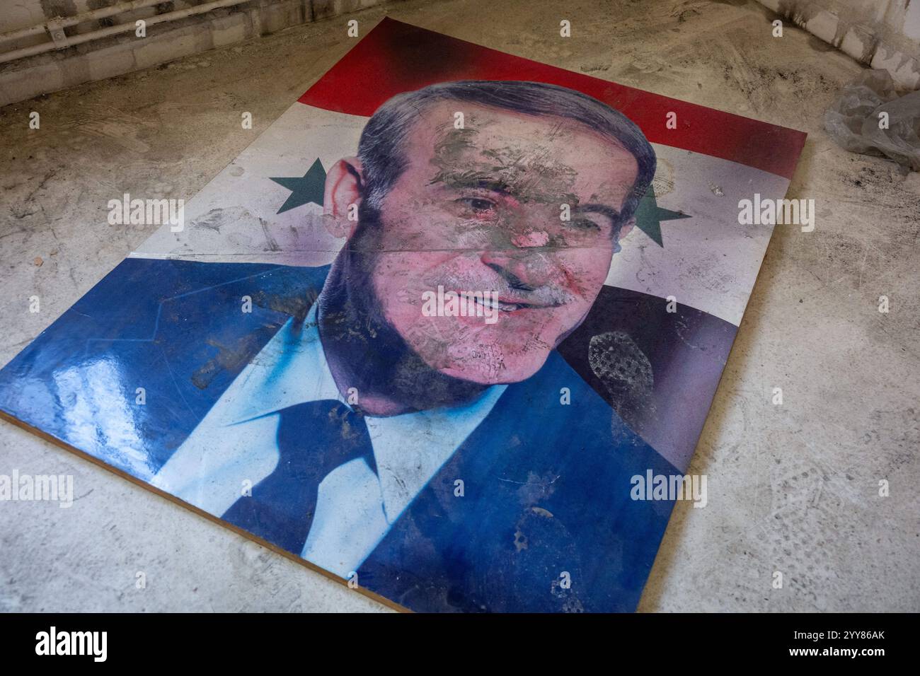Damascus, Syria. 19th Dec, 2024. Destroyed portrait of Hafez El Assad ...