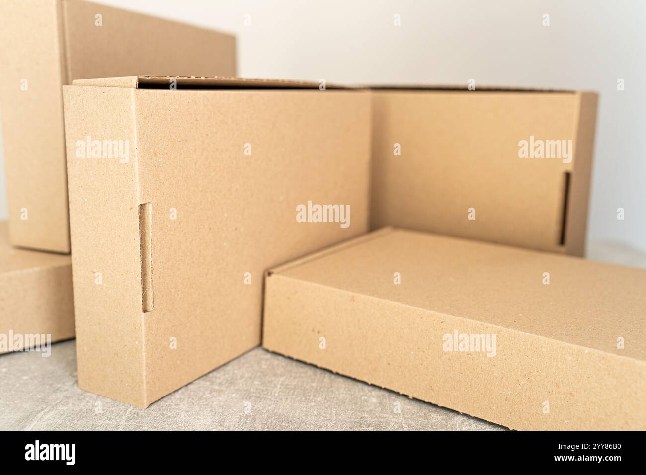 A set of self-assembly kraft cardboard boxes displayed on a textured ...