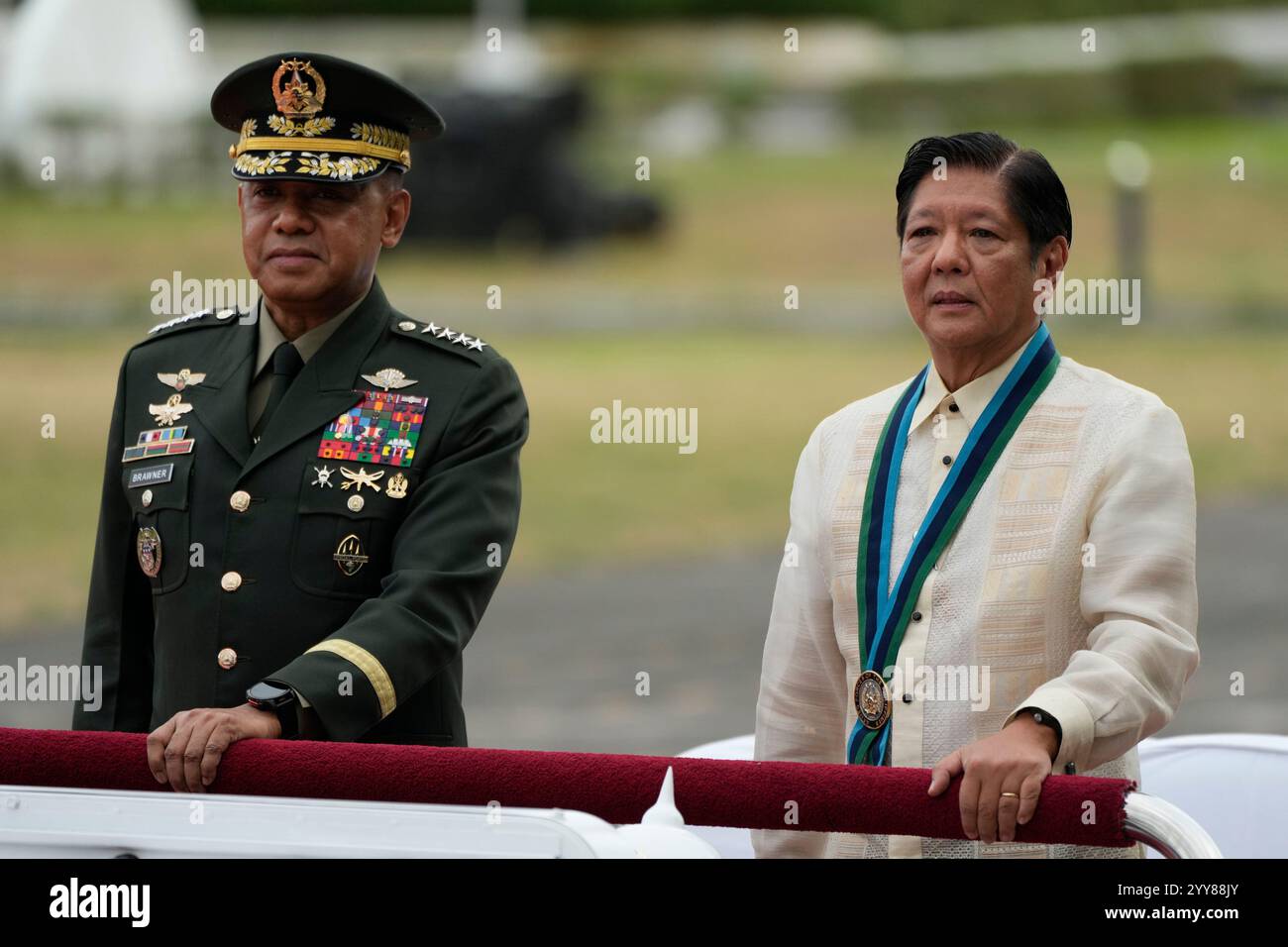 Philippine President Ferdinand Marcos Jr., right, rides beside ...