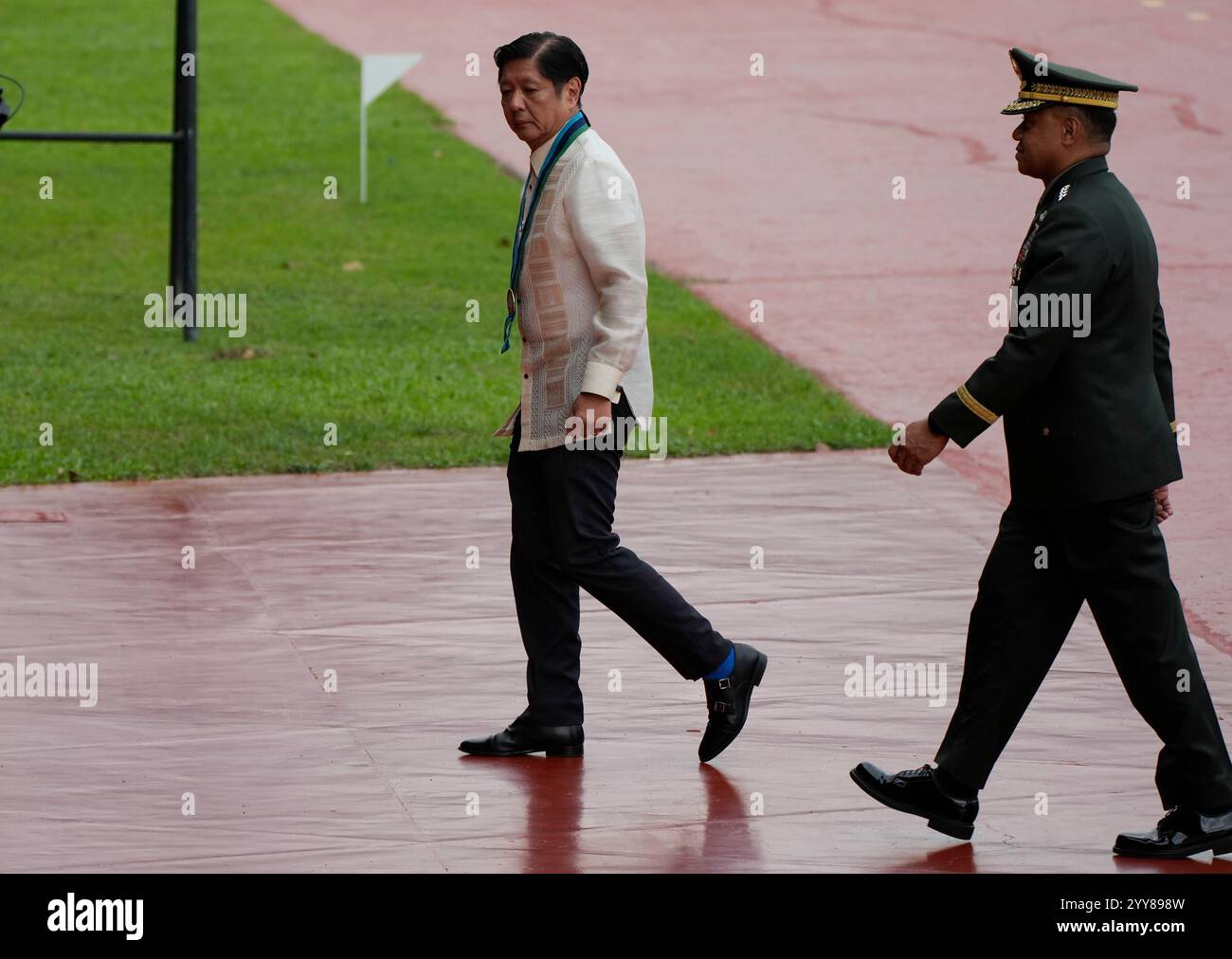 Philippine President Ferdinand Marcos Jr., left, walks beside ...