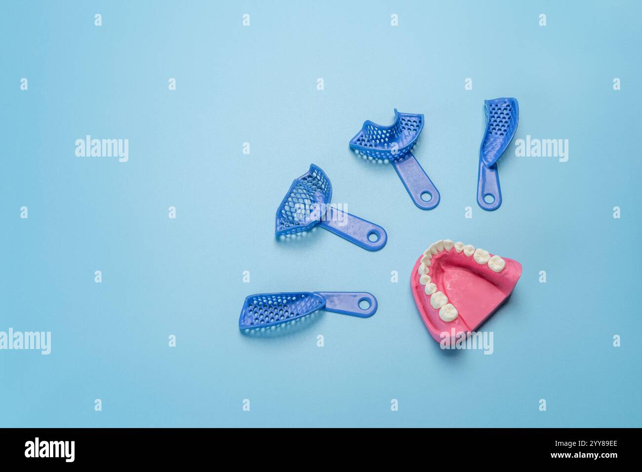 Set of dental flexible impression trays with a layout of the human jaw ...
