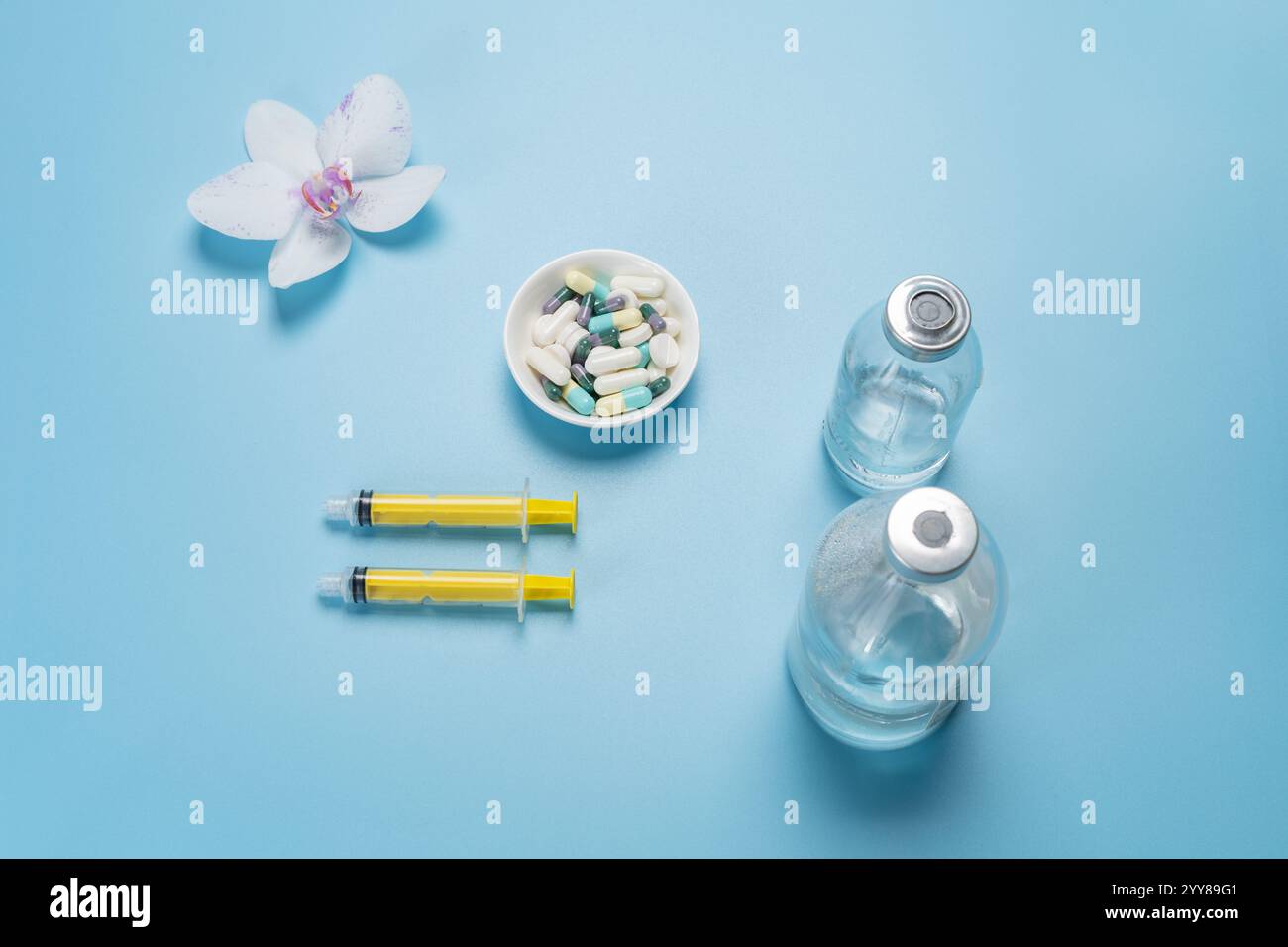 Glass bottles of liquid medicine, plastic syringes for injection, a ...