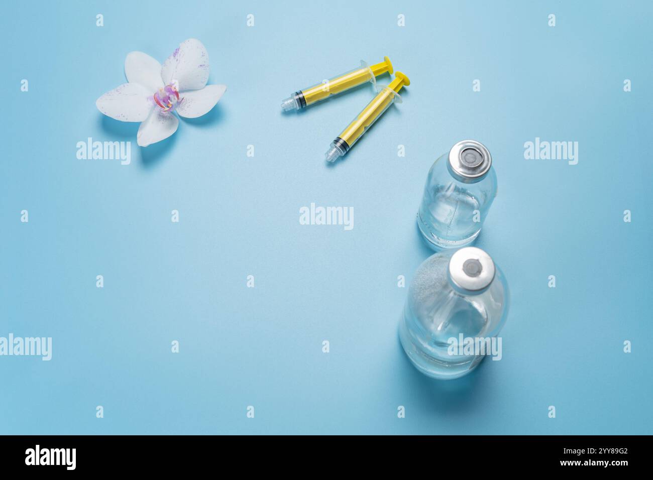 Glass bottles of liquid medicine, plastic syringes for injection and an ...