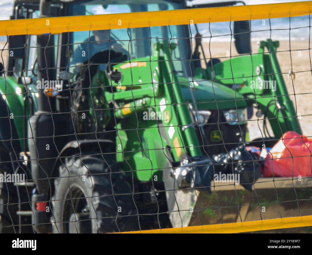Municipal tractor is cleaning the sandy beach Photographed in Bat Yam ...
