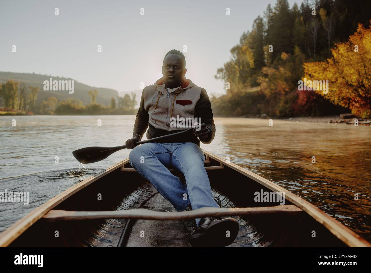 Man Paddling Vintage Canoe On River While Looking Thoughtful Stock ...