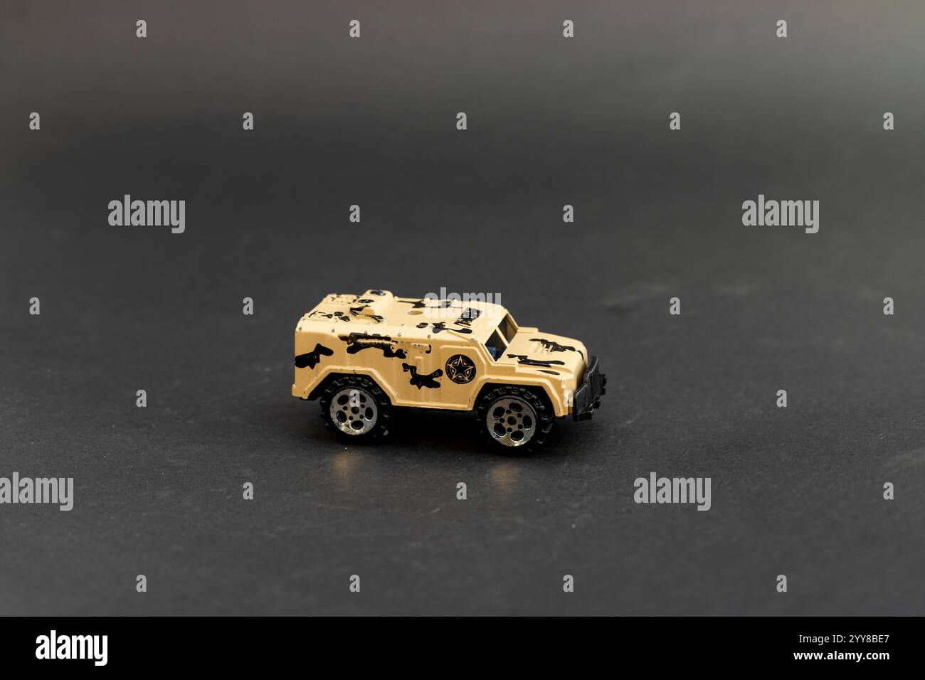 Side view of tan military vehicle model with star insignia Stock Photo ...