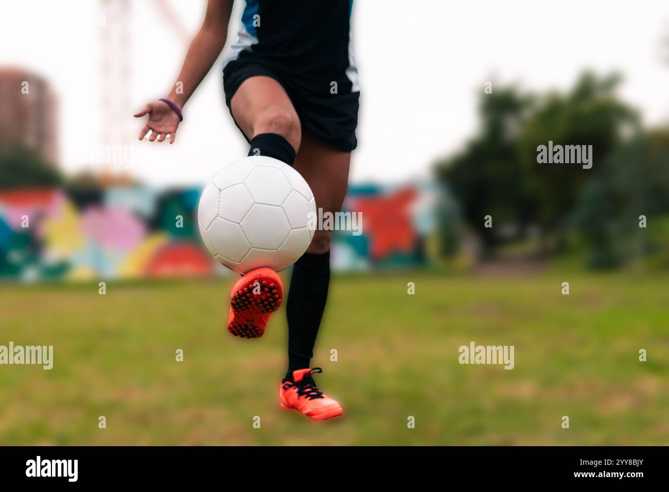 Female soccer player running to kick soccer ball Stock Photo - Alamy
