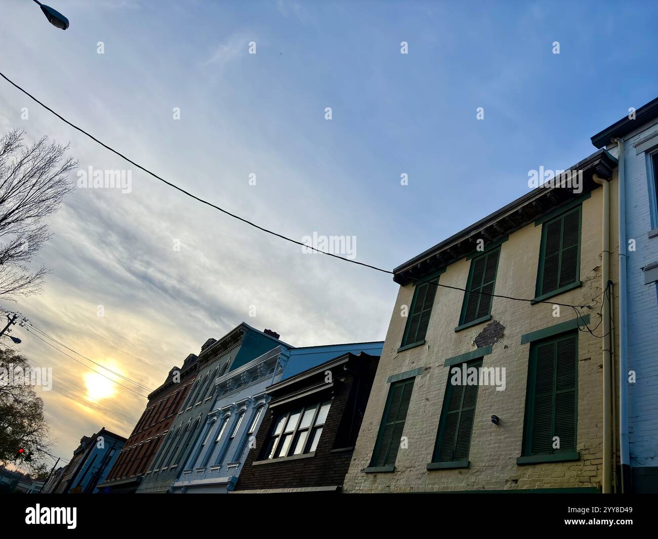 Sun setting behind historic brick buildings in Covington, KY Stock ...