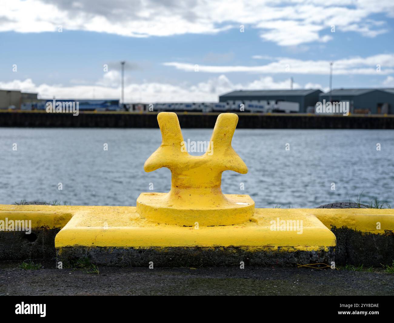 Yellow maritime bollard on the harbor Stock Photo - Alamy