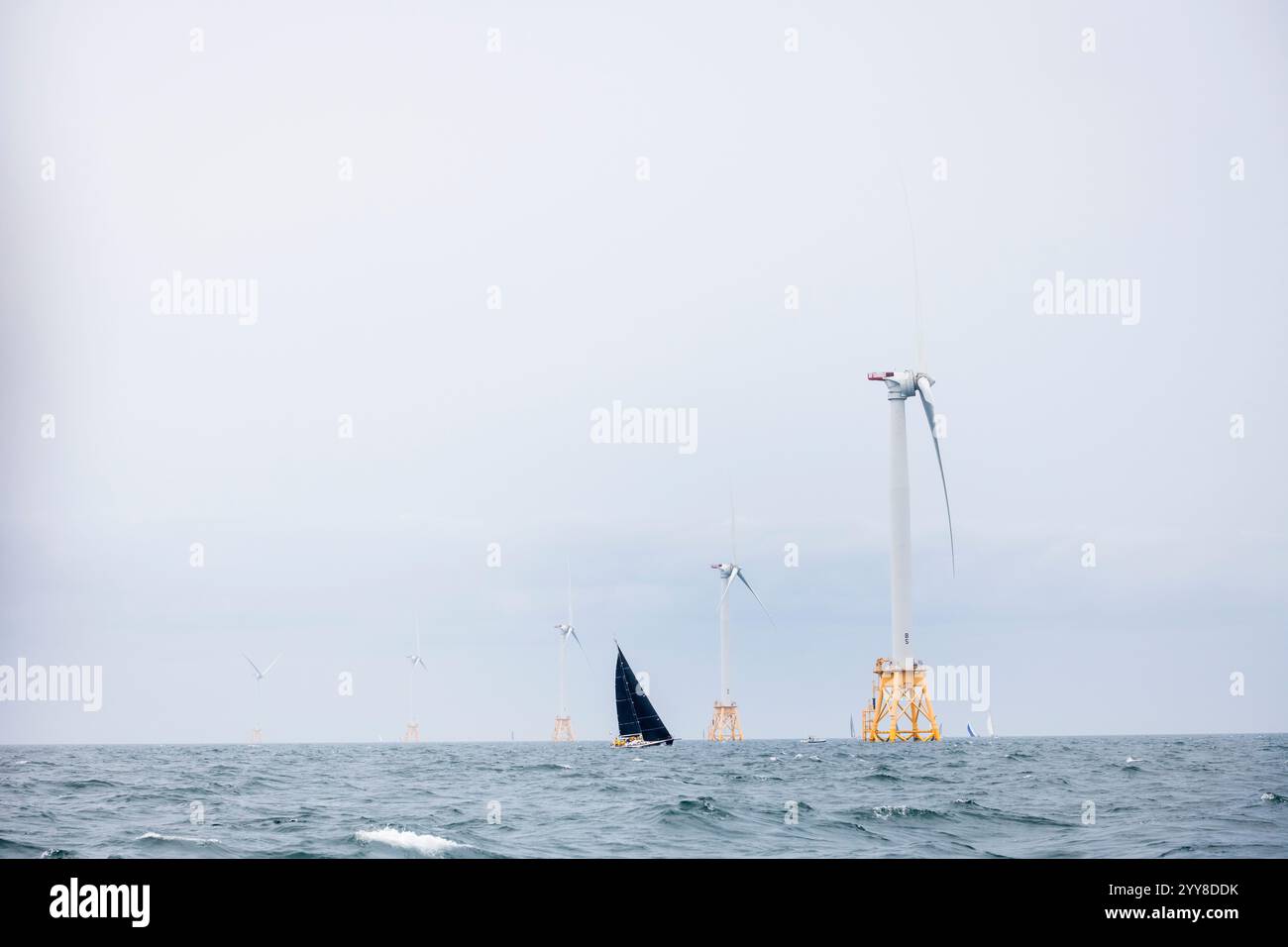 Boats sailing by Wind Turbines in the Block Island Race Week regatta ...