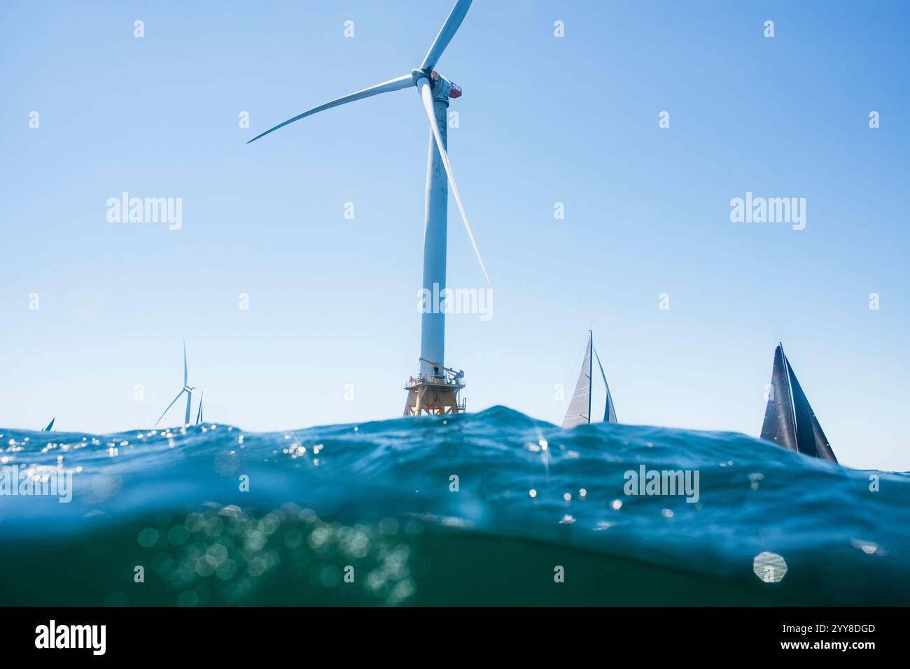 Boats sailing by Wind Turbines in New England Stock Photo - Alamy