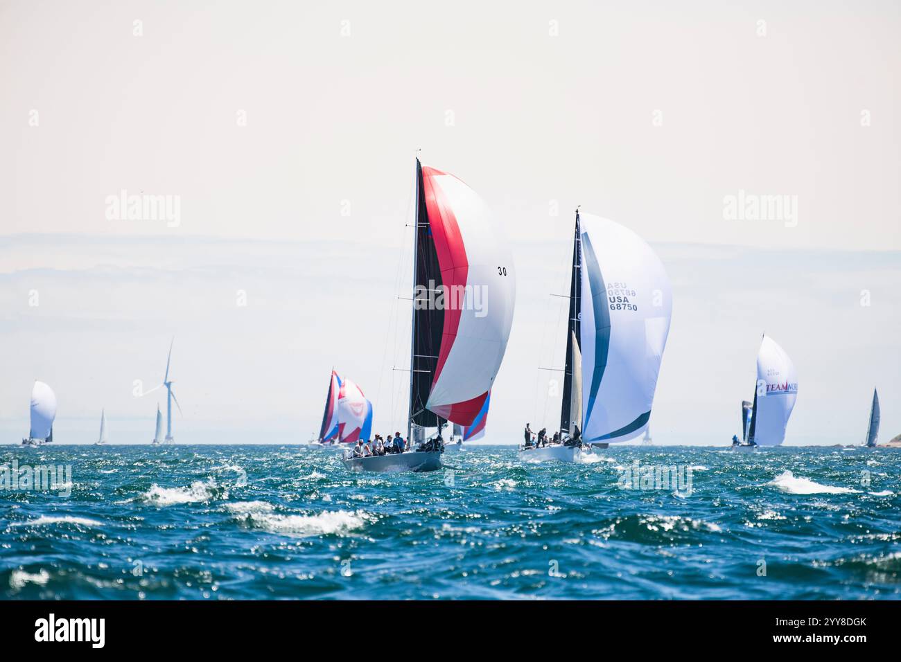 Boats sailing by Wind Turbines in the Block Island Race Week regatta ...