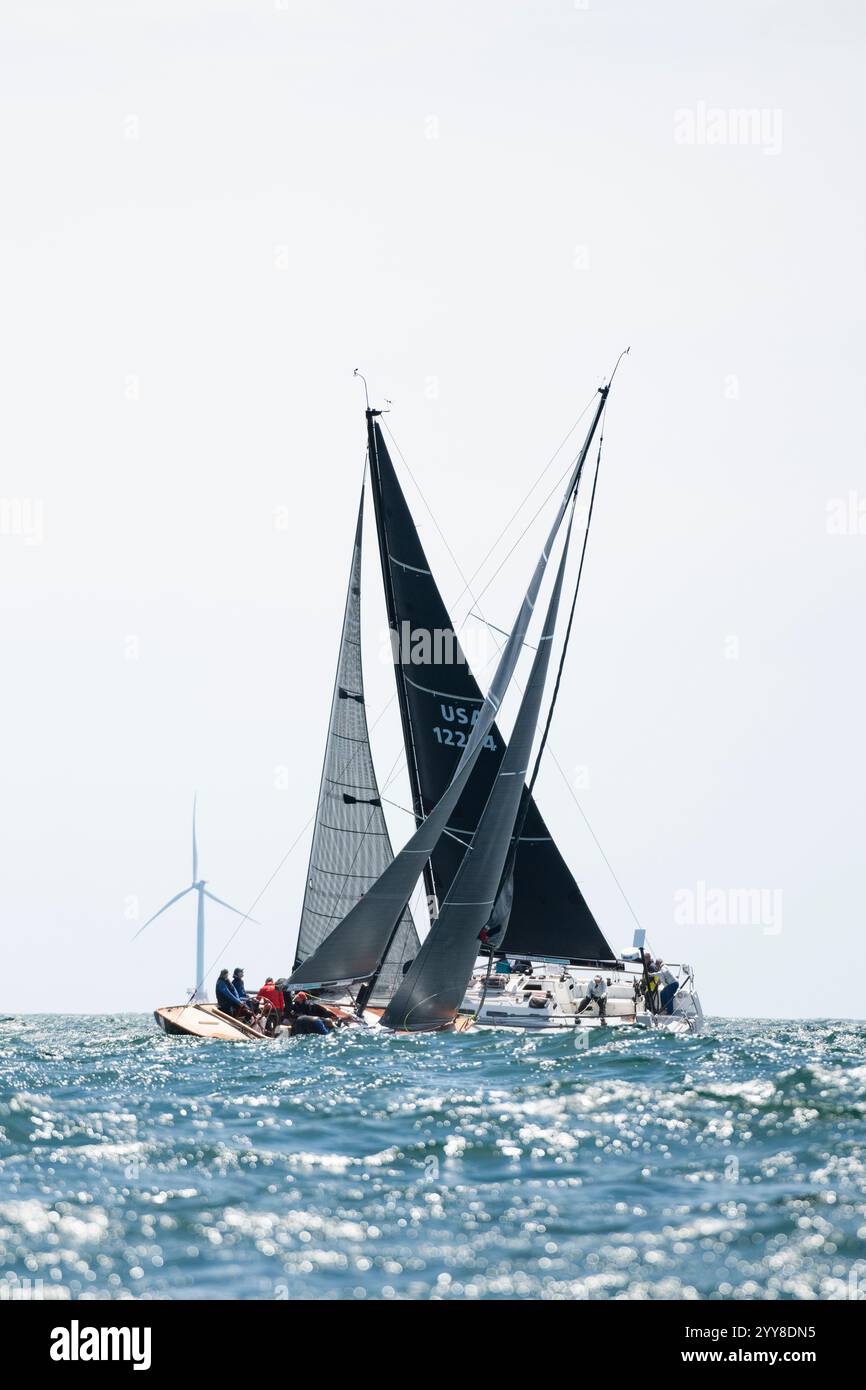 Boats sailing by Wind Turbines in the Block Island Race Week regatta ...