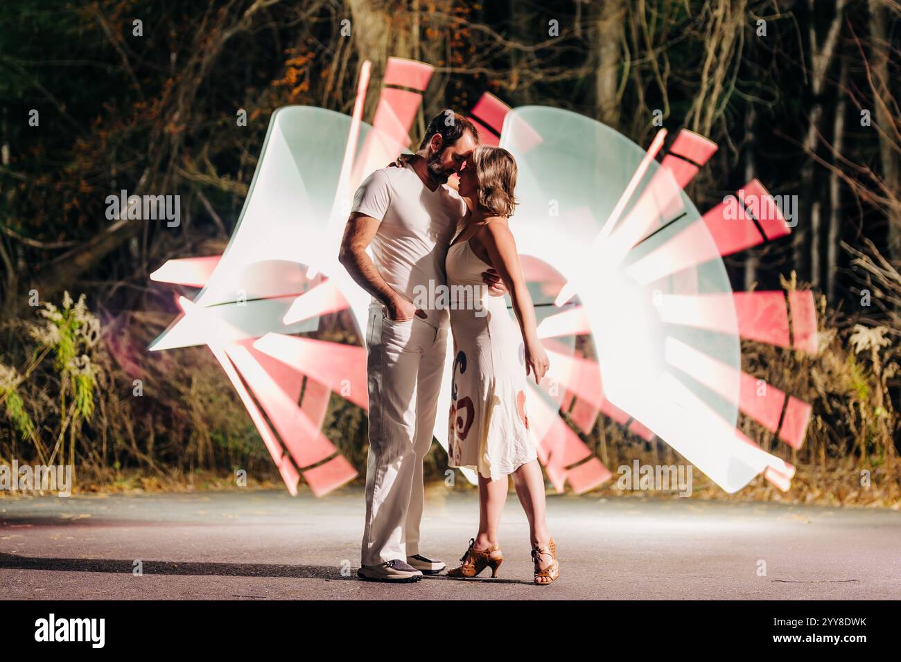 Couple embracing with light painting creating dynamic arcs Stock Photo ...