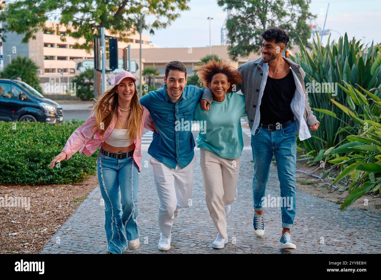 Friends enjoy a joyful walk together along a urban pathway Stock Photo ...